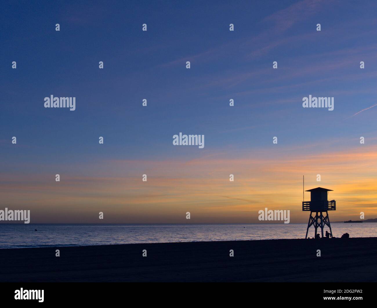 Silhouette at sunset of a guard post on the beach. Lifeguard tower on ...