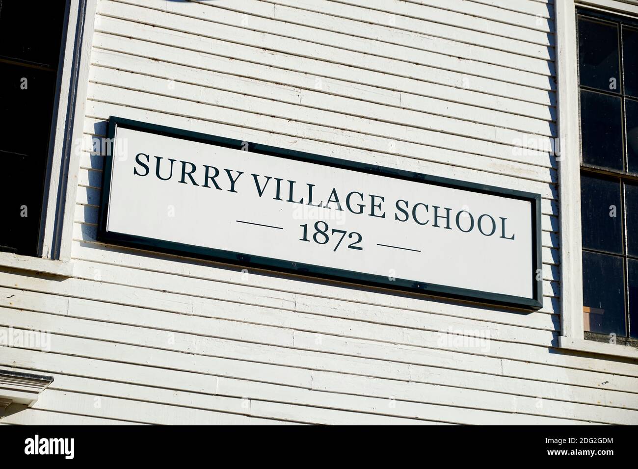 Close up of the sign of the old, white, clapboard, siding Surry Village ...