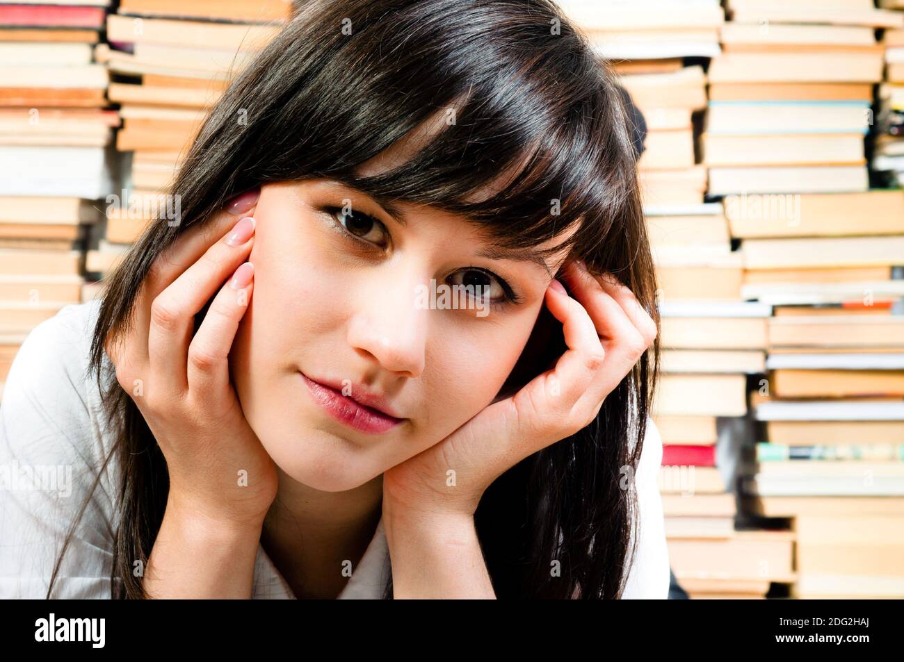 Young student reading a book in the library Stock Photo - Alamy