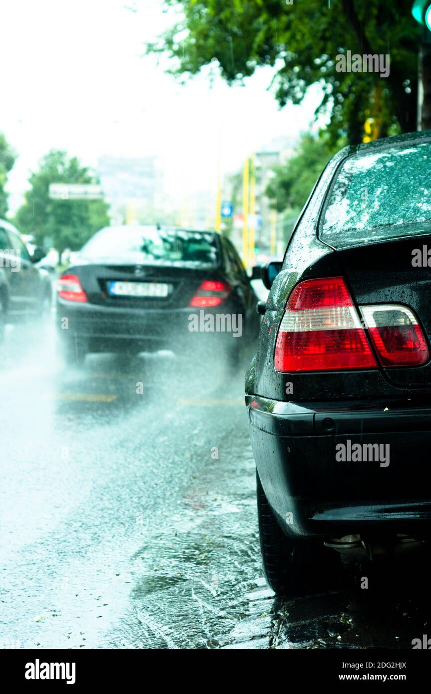 Parked car in rain with blurry background Stock Photo - Alamy