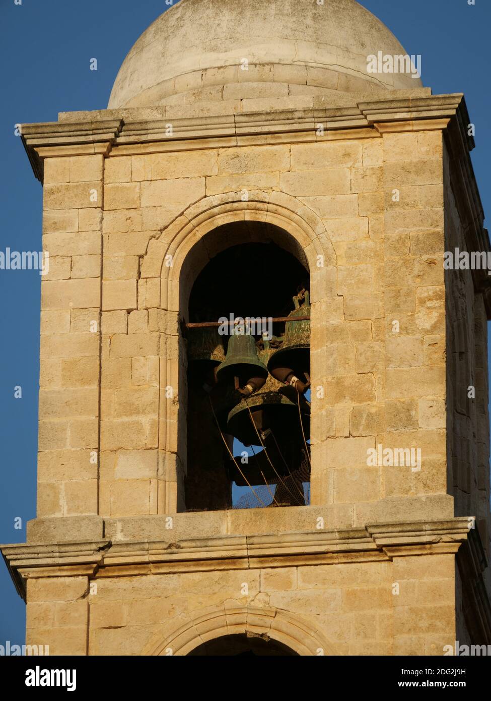 A vertical shot of metal bells in a stone tow Stock Photo - Alamy