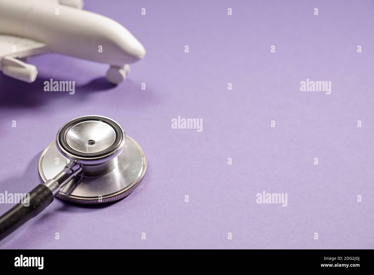 Stethoscope and orange cannula syringe, with lilac background, black ...