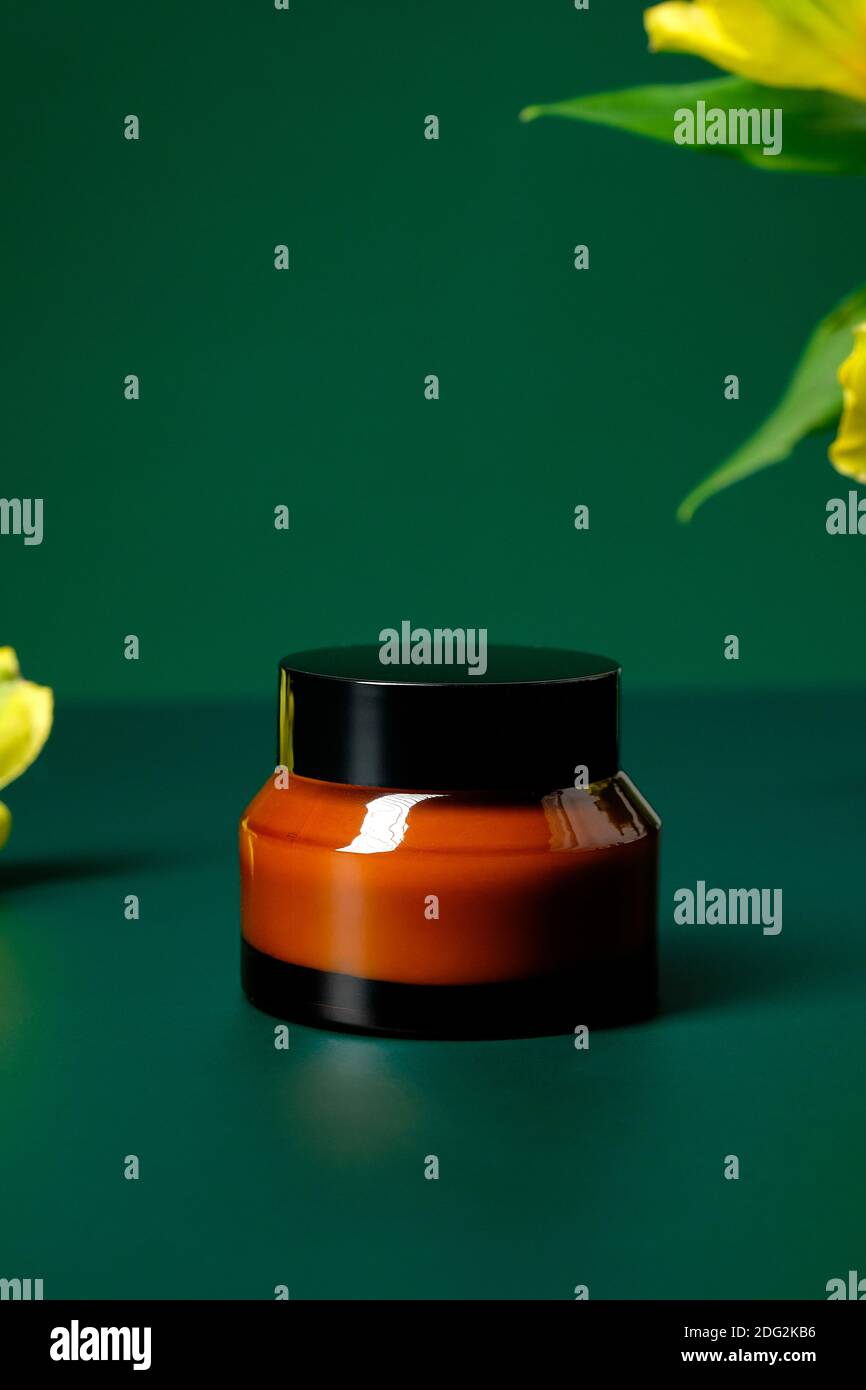 Jar of natural moisturizing cream for hand care. Brown amber glass ...