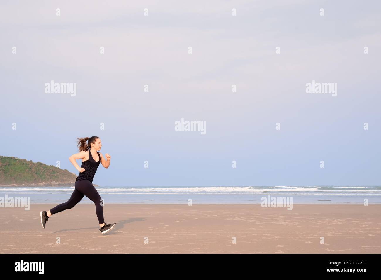 Woman running on beach exercising hi-res stock photography and images ...