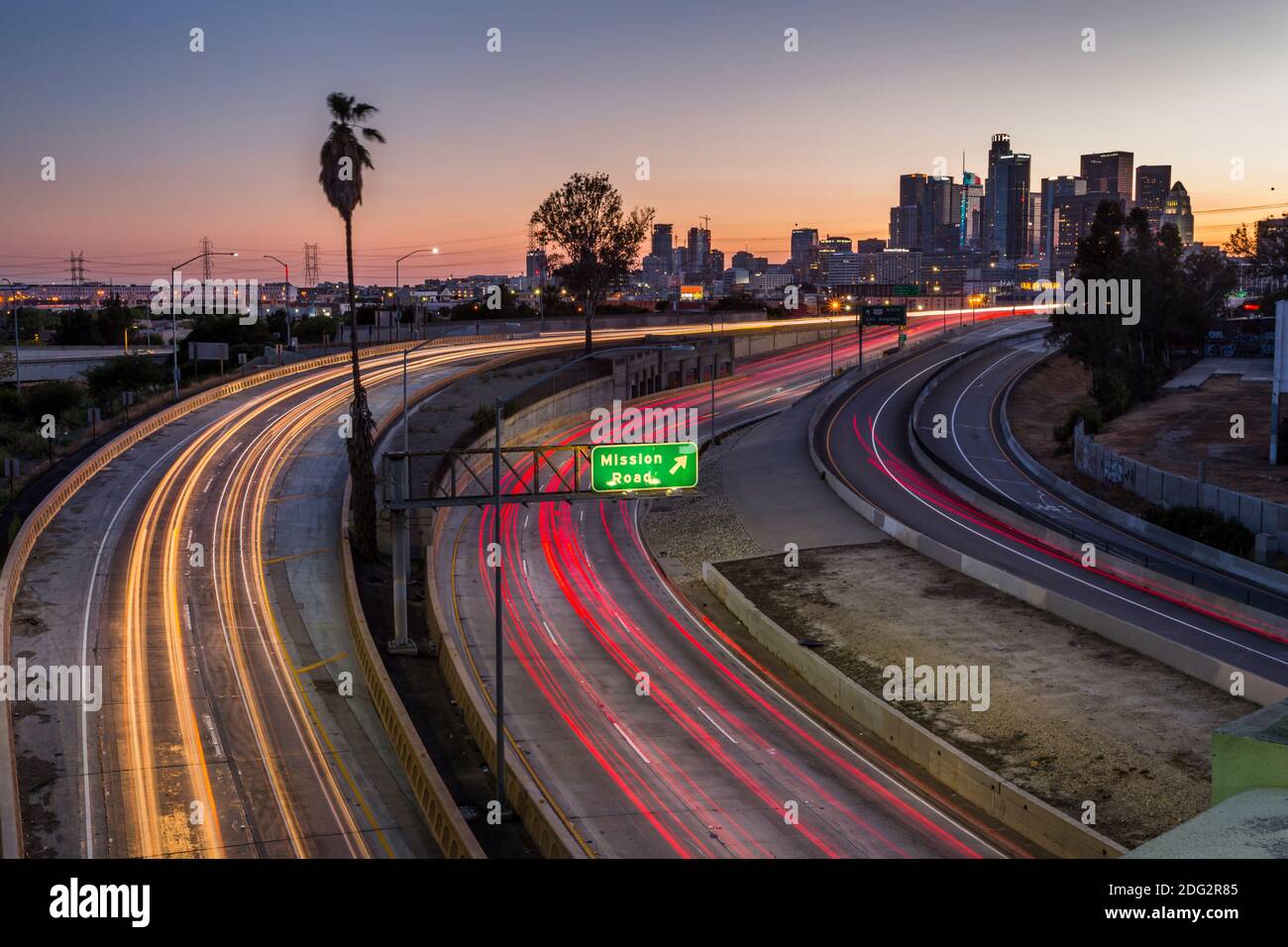 View of Downtown LA and freeway trail lights at sunset, Los Angeles ...