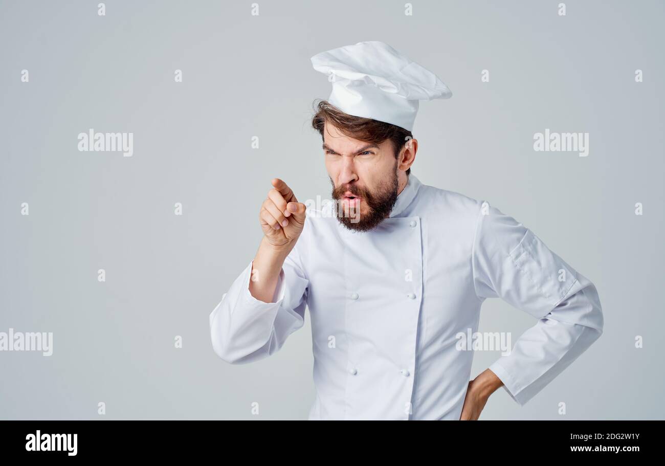 A man in light clothes, a chef gestures with his hands Copy Space gray ...