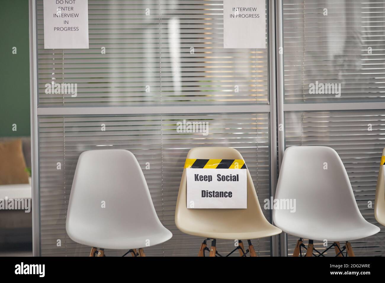 Background image of chairs in row with Keep social distance sign at ...