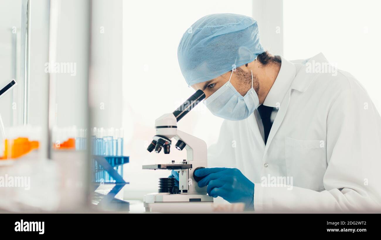 close up. scientist looking into the eyepiece of a microscope Stock ...