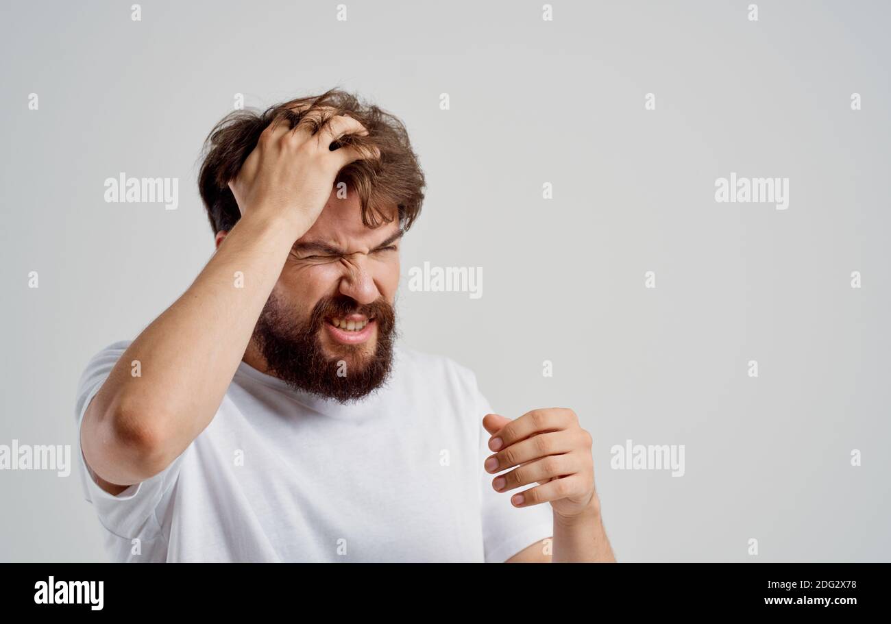 bearded man holding his head discontent migraine health problems Stock ...