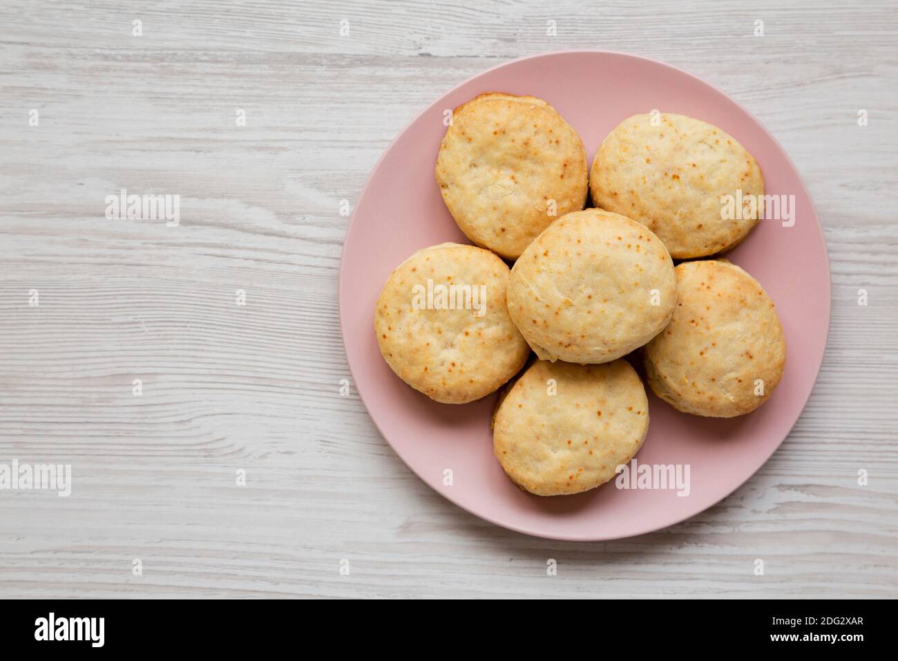 Homemade Flaky Buttermilk Biscuits on a pink plate on a white wooden ...