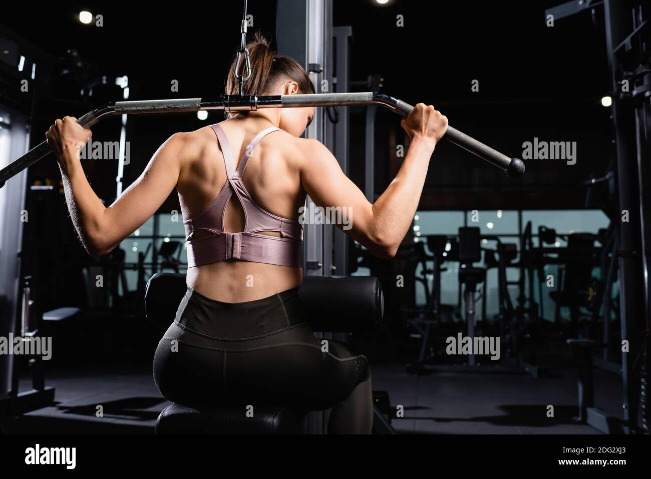 back view of athletic sportswoman doing back and arms extension ...