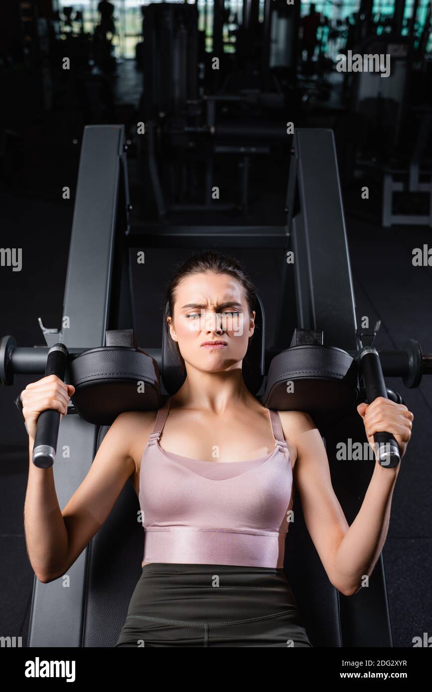 top view of sportswoman with closed eyes training on arms extension ...