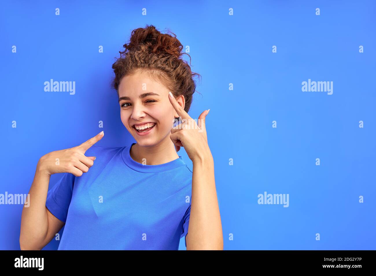 cute joydul cheerful girl have fun posing isolated in studio with blue ...