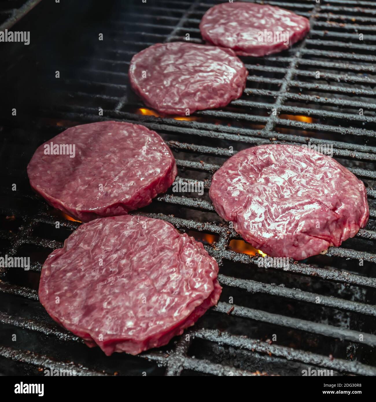 Tasty beef burgers on the grill Stock Photo - Alamy