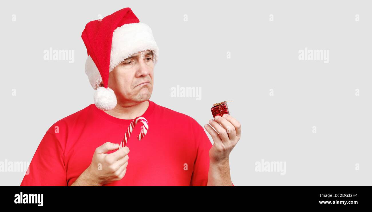 Hand holds candy cane hi-res stock photography and images - Alamy