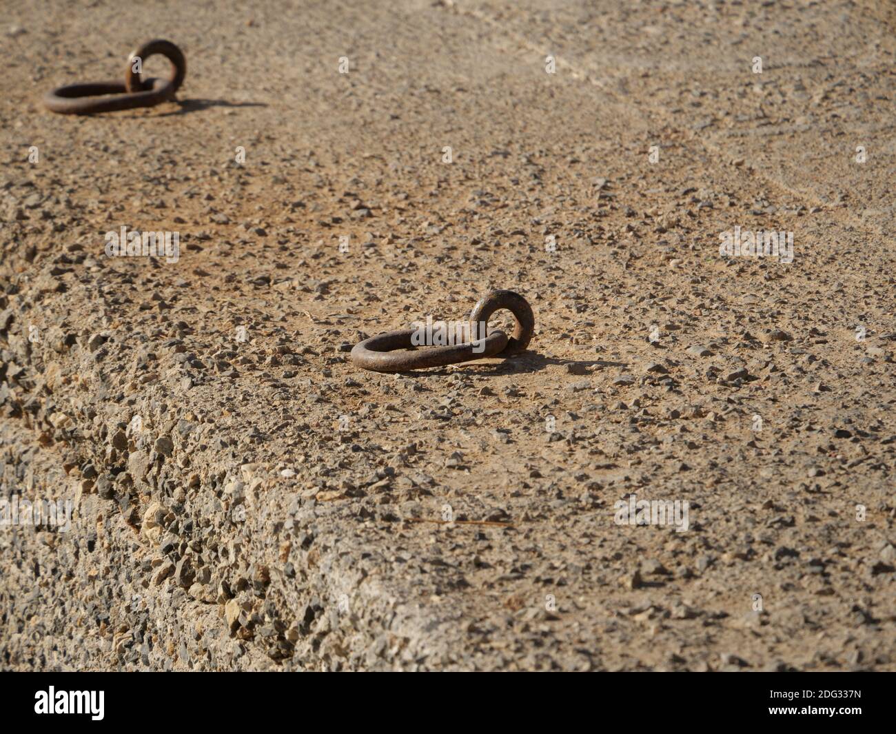 A view of iron rings on a concrete surface Stock Photo - Alamy