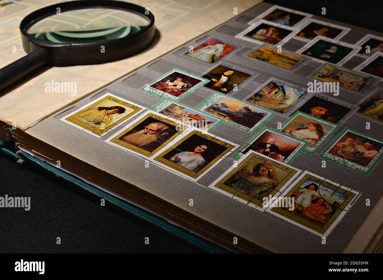 Open album with stamps and a magnifier located on a dark desk Stock ...