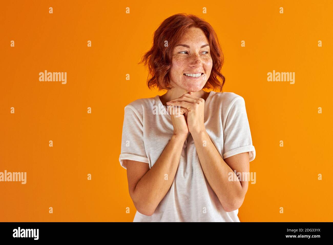 excited lady in casual wear stand in contemplation, dreaming, thinking ...