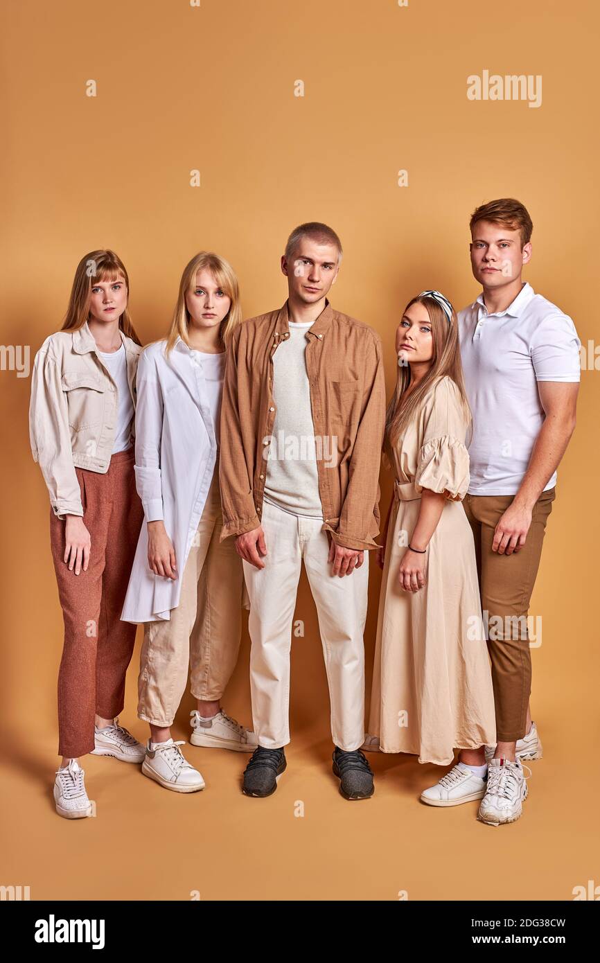 unusual group of extraordinary youth posing in trendy wear, caucasian ...
