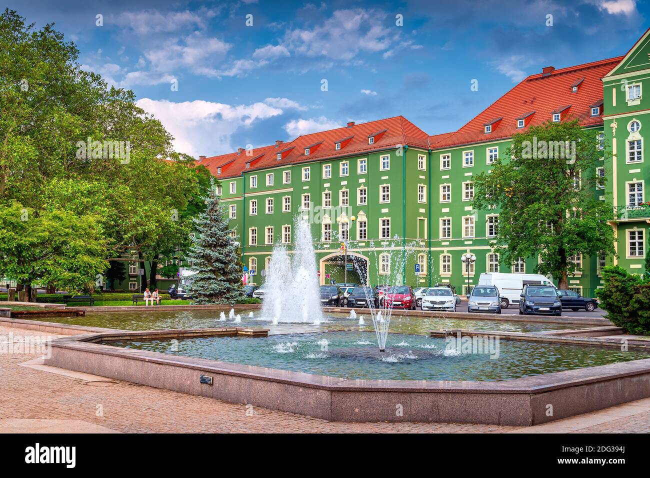 Green buildings of Szczecin City Council with red rooftops. Fountains ...