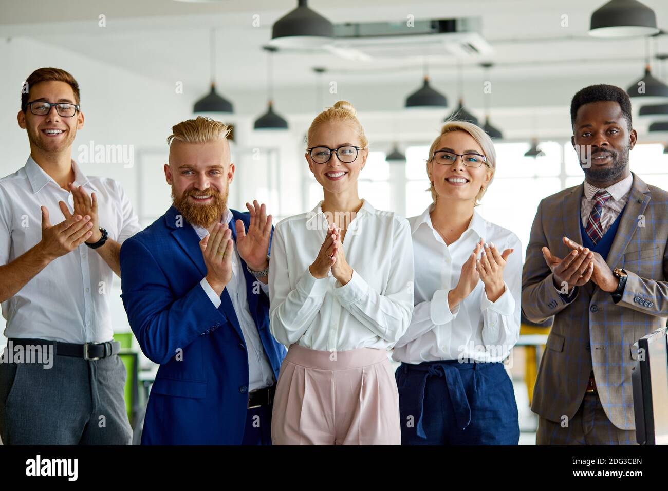 Happy students clapping hands hi-res stock photography and images - Alamy
