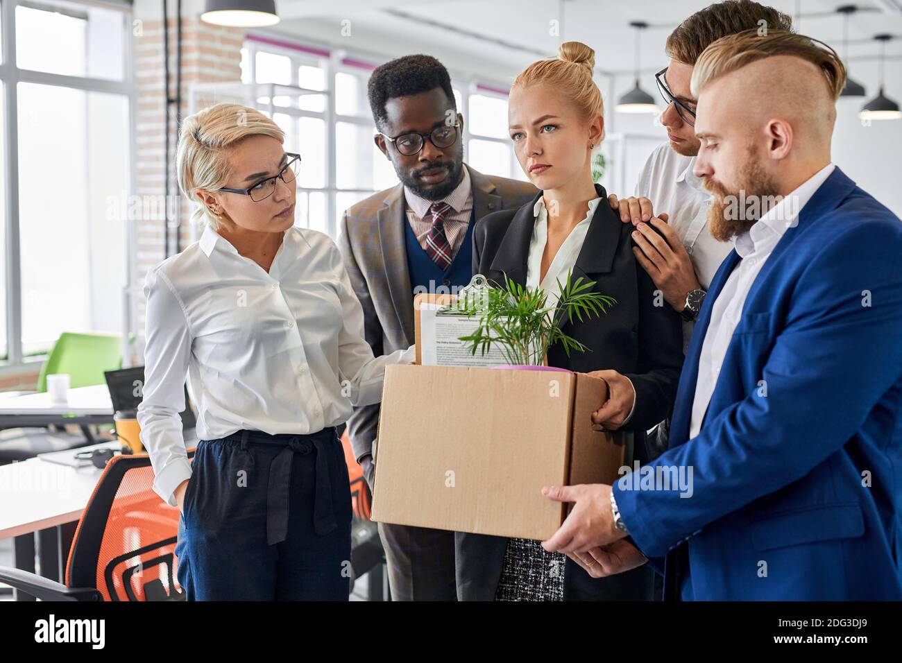 team of workers support their female colleague leaving work, she stand ...