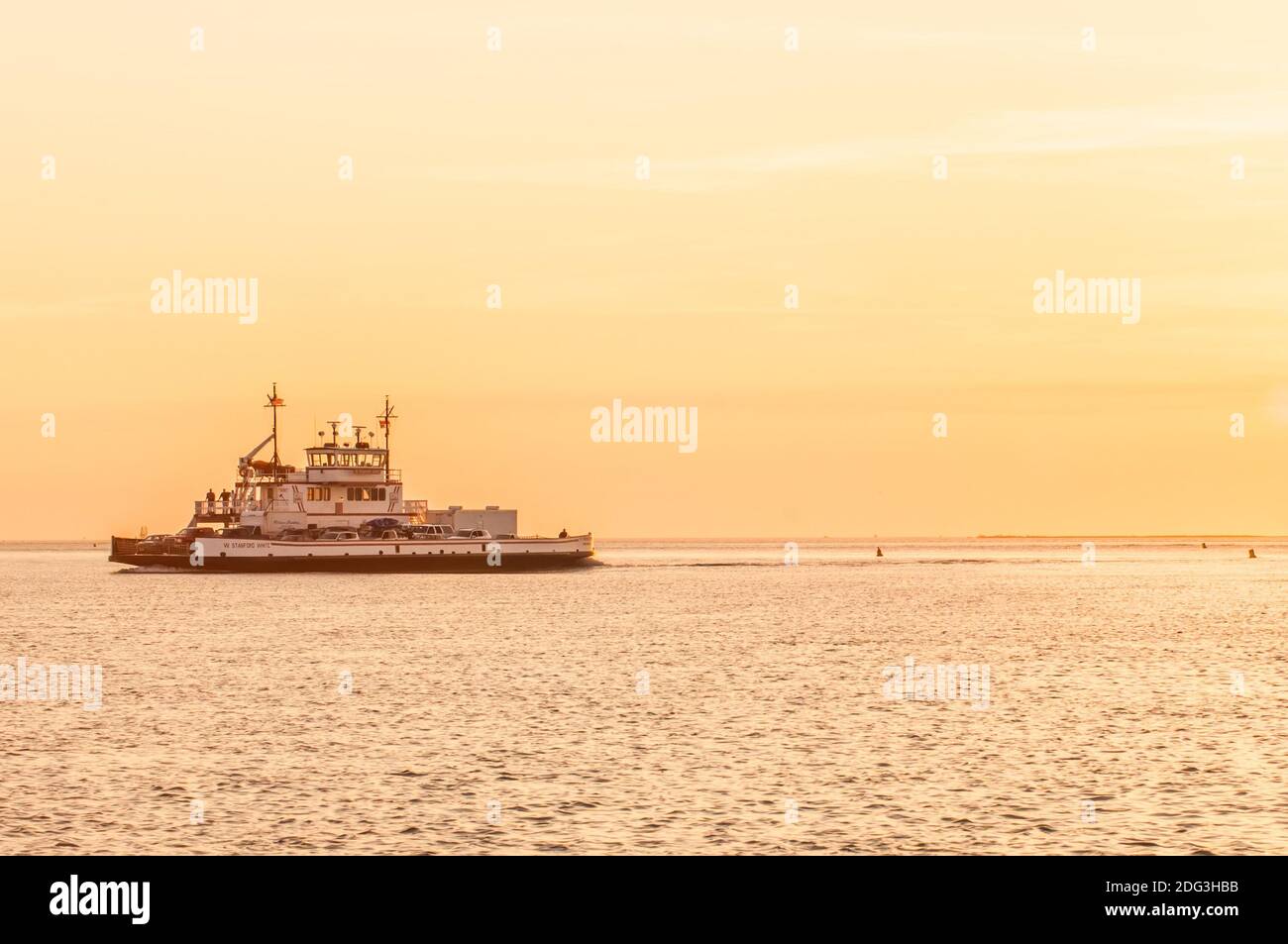 Sunset on sea with ferry in distance Stock Photo - Alamy