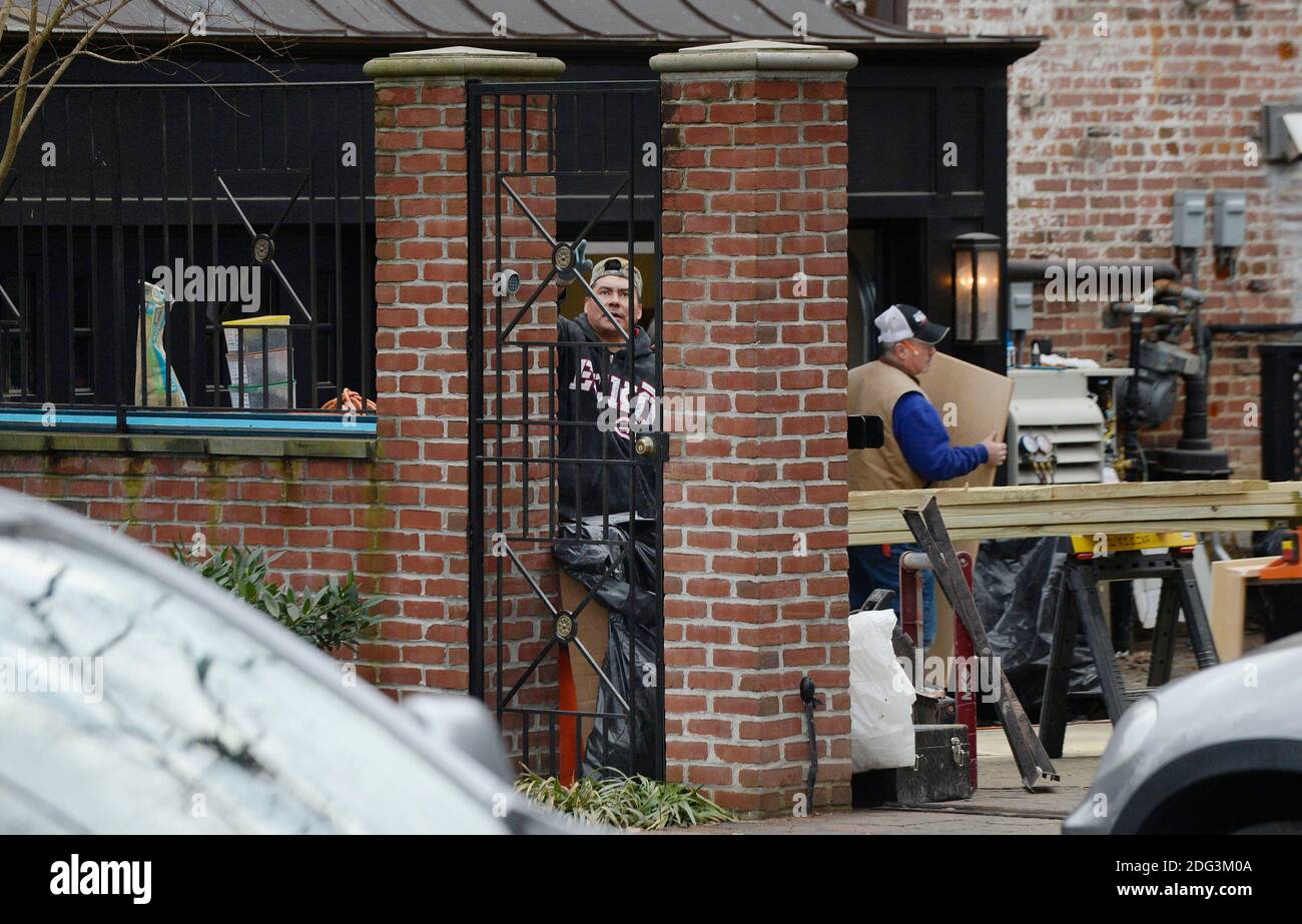 Workers are seen working on the fence of President Barack Obama 's home ...