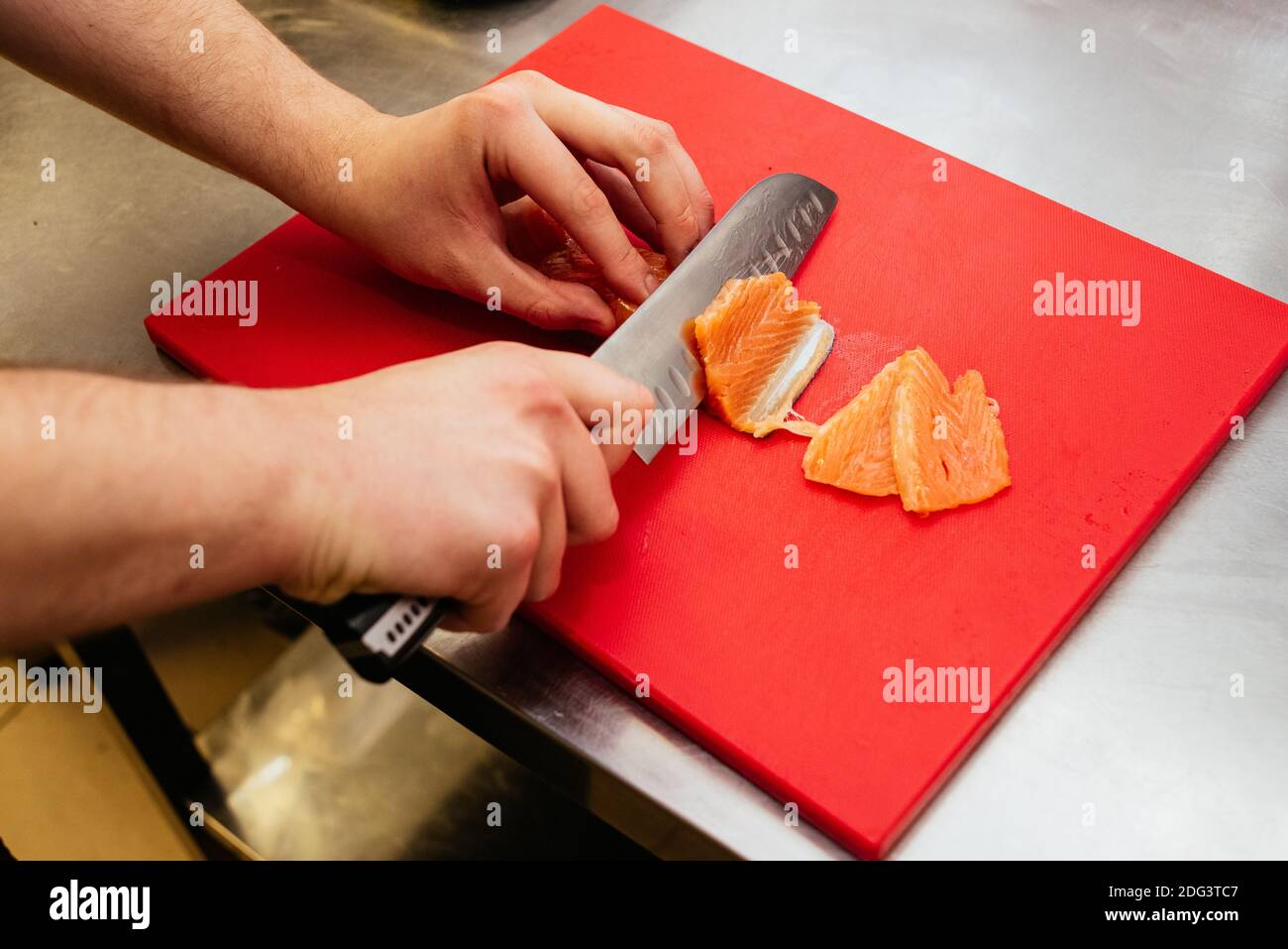 men's hands butchering fish in the kitchen Stock Photo - Alamy
