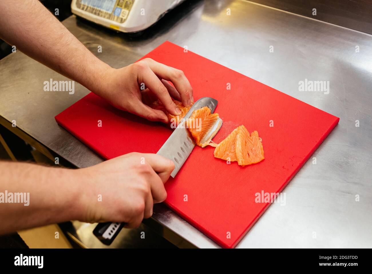 men's hands butchering fish in the kitchen Stock Photo - Alamy
