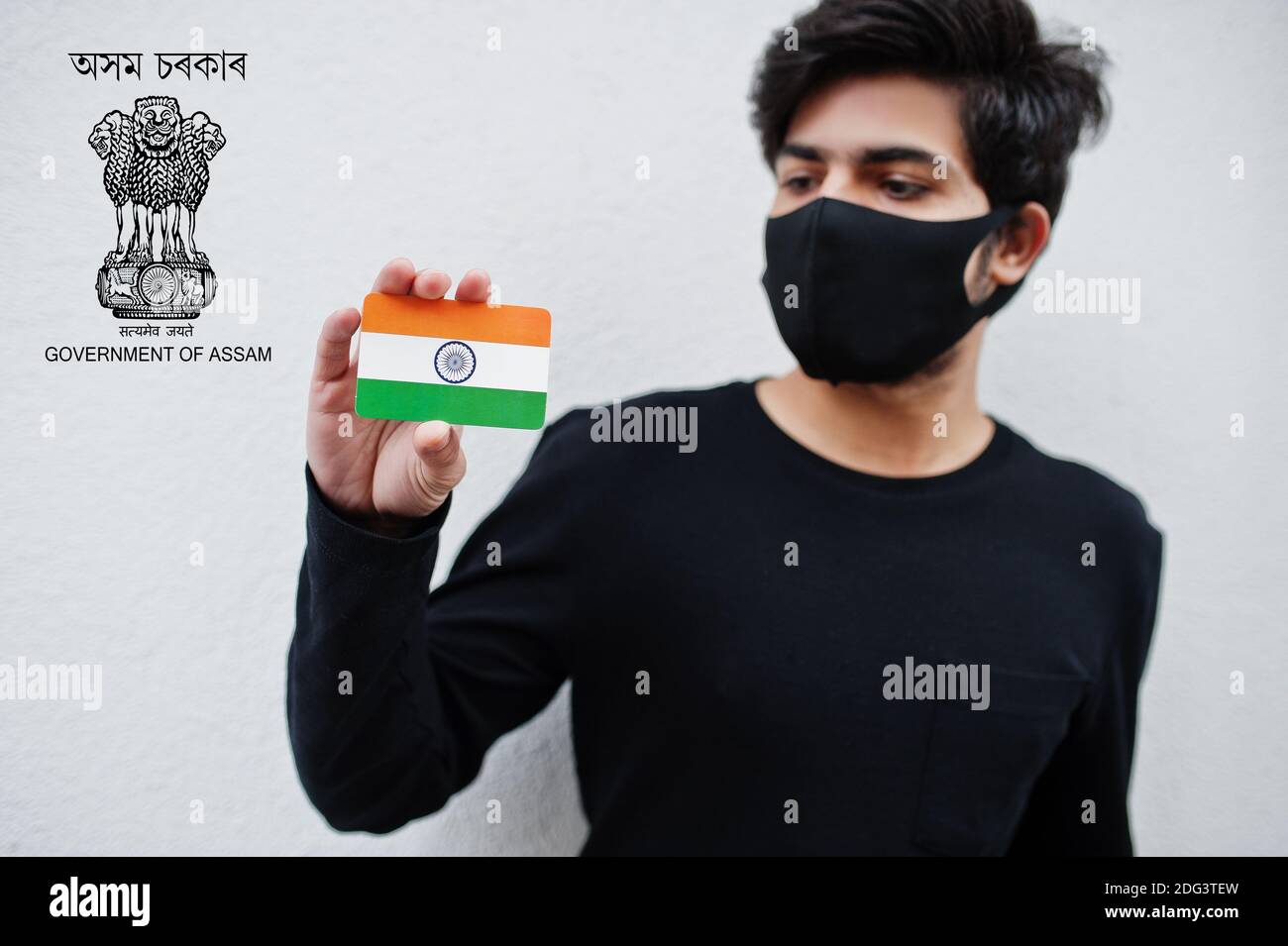 Indian man wear all black and face mask, hold India flag in hand ...