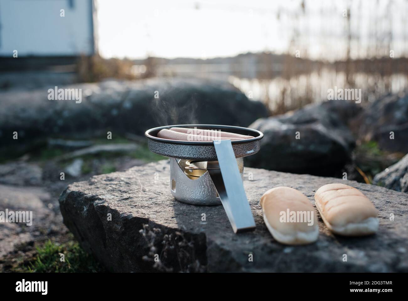 food cooking on an outdoor fire at the beach at sunset in Sweden Stock ...