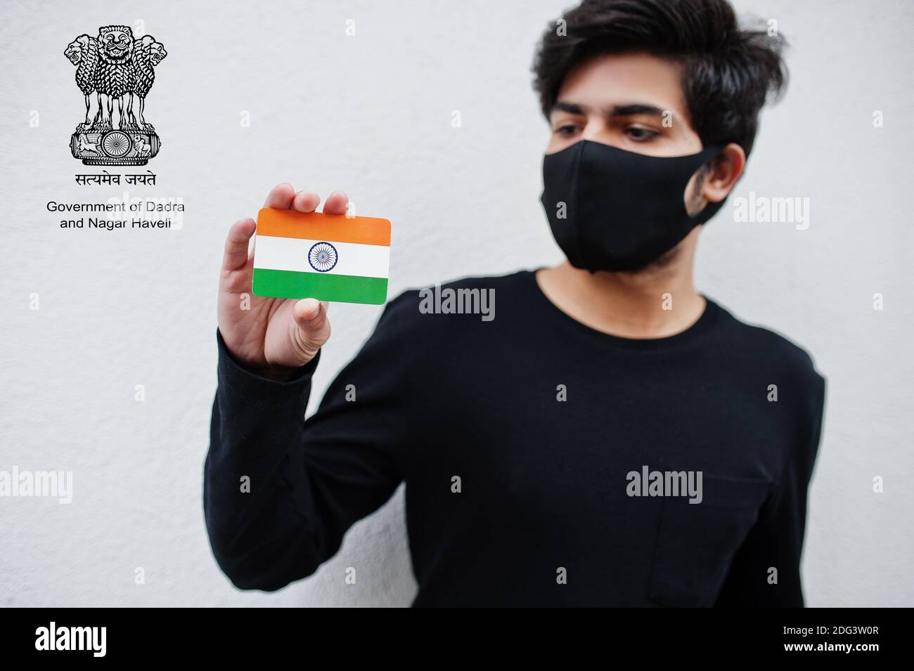 Indian man wear all black and face mask, hold India flag in hand ...