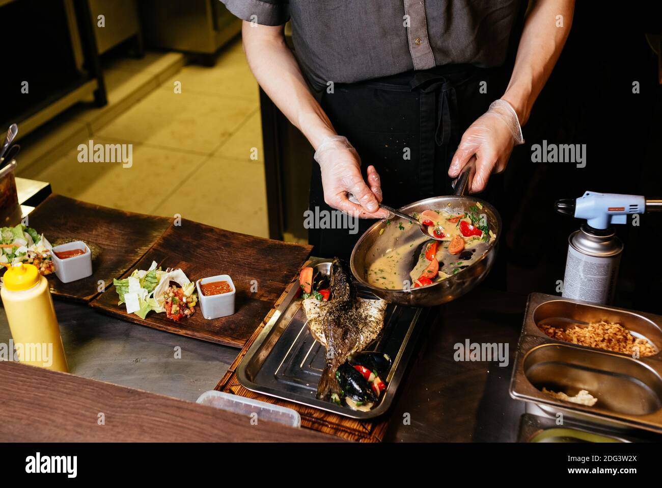 Woman chef grill fish hi-res stock photography and images - Alamy