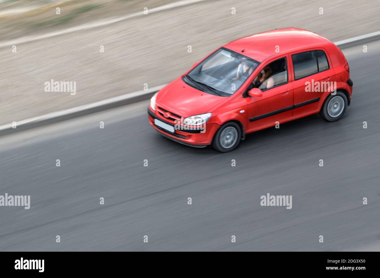 Red car moving Stock Photo - Alamy