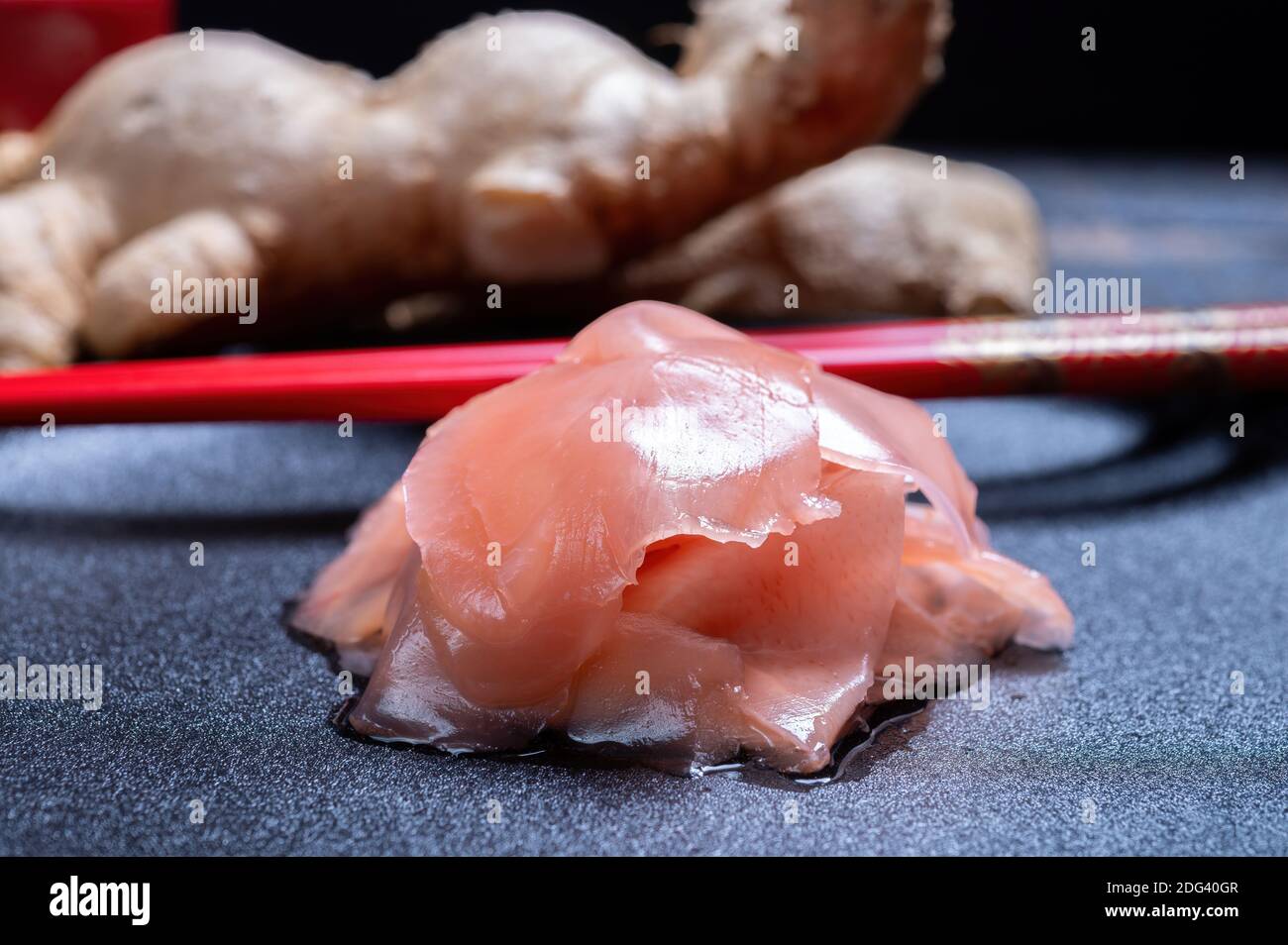 Asian food, pink sliced pickled ginger roots ready to eat, close up ...