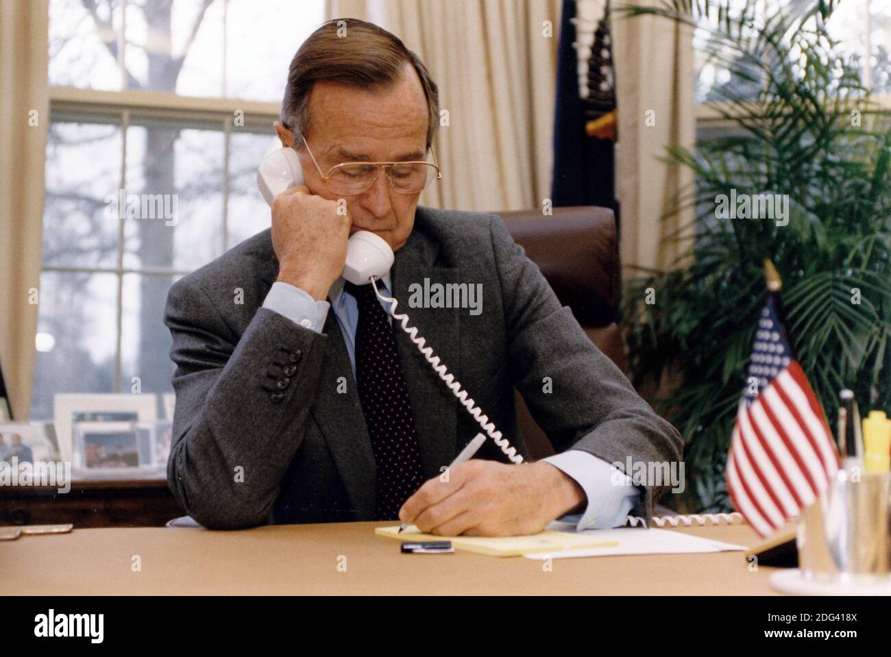 United States President George H.W. Bush speaks on the telephone with ...