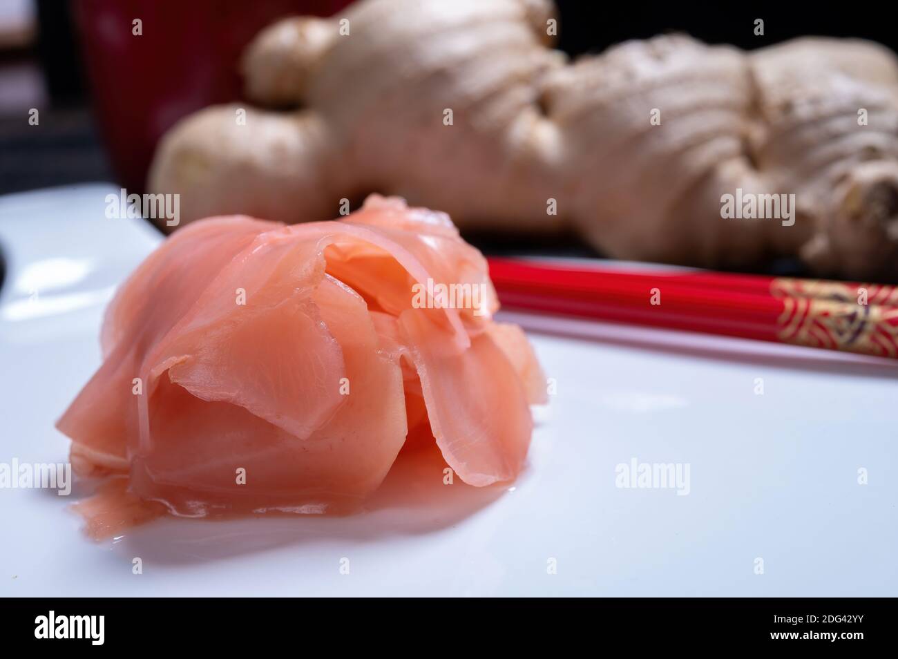 Asian food, pink sliced pickled ginger roots ready to eat, close up ...