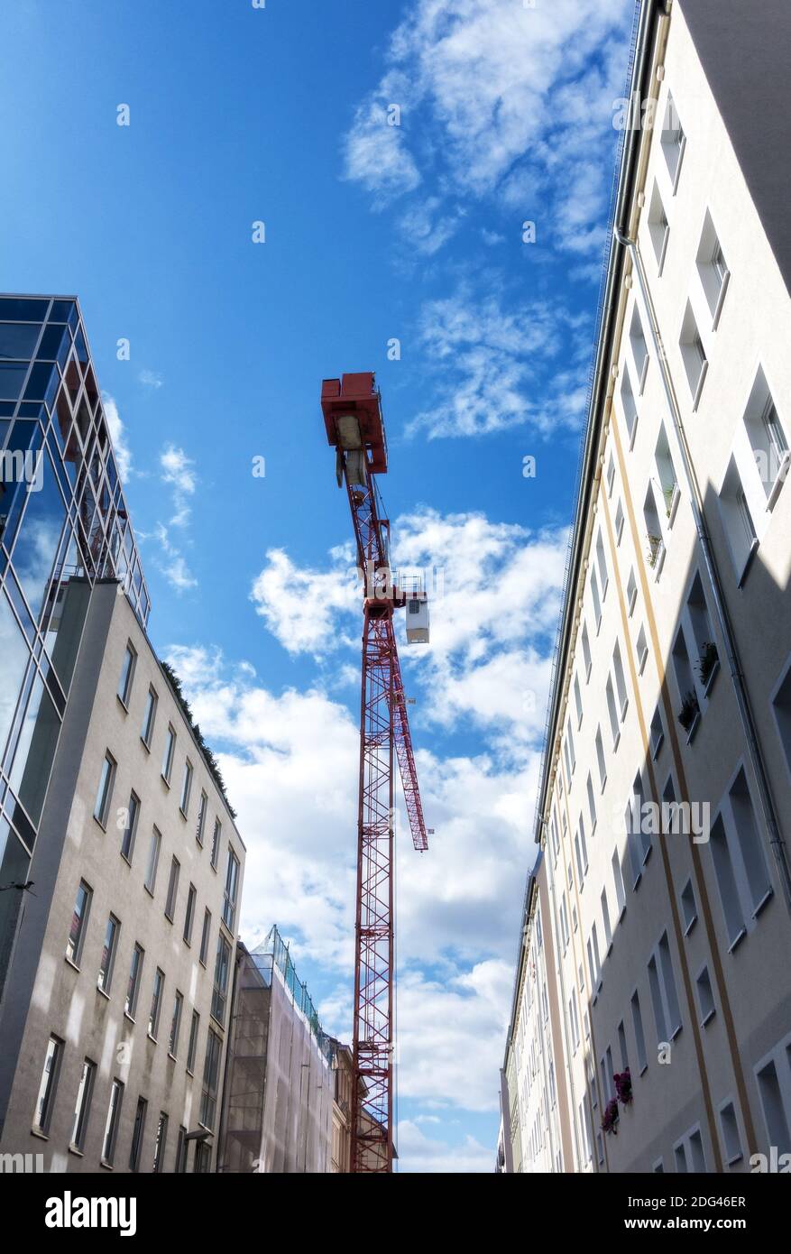 Construction crane in narrow street Stock Photo - Alamy