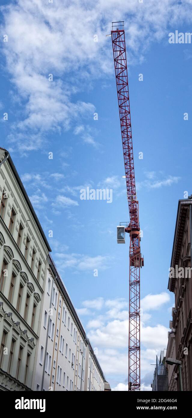 Construction crane in narrow street Stock Photo - Alamy