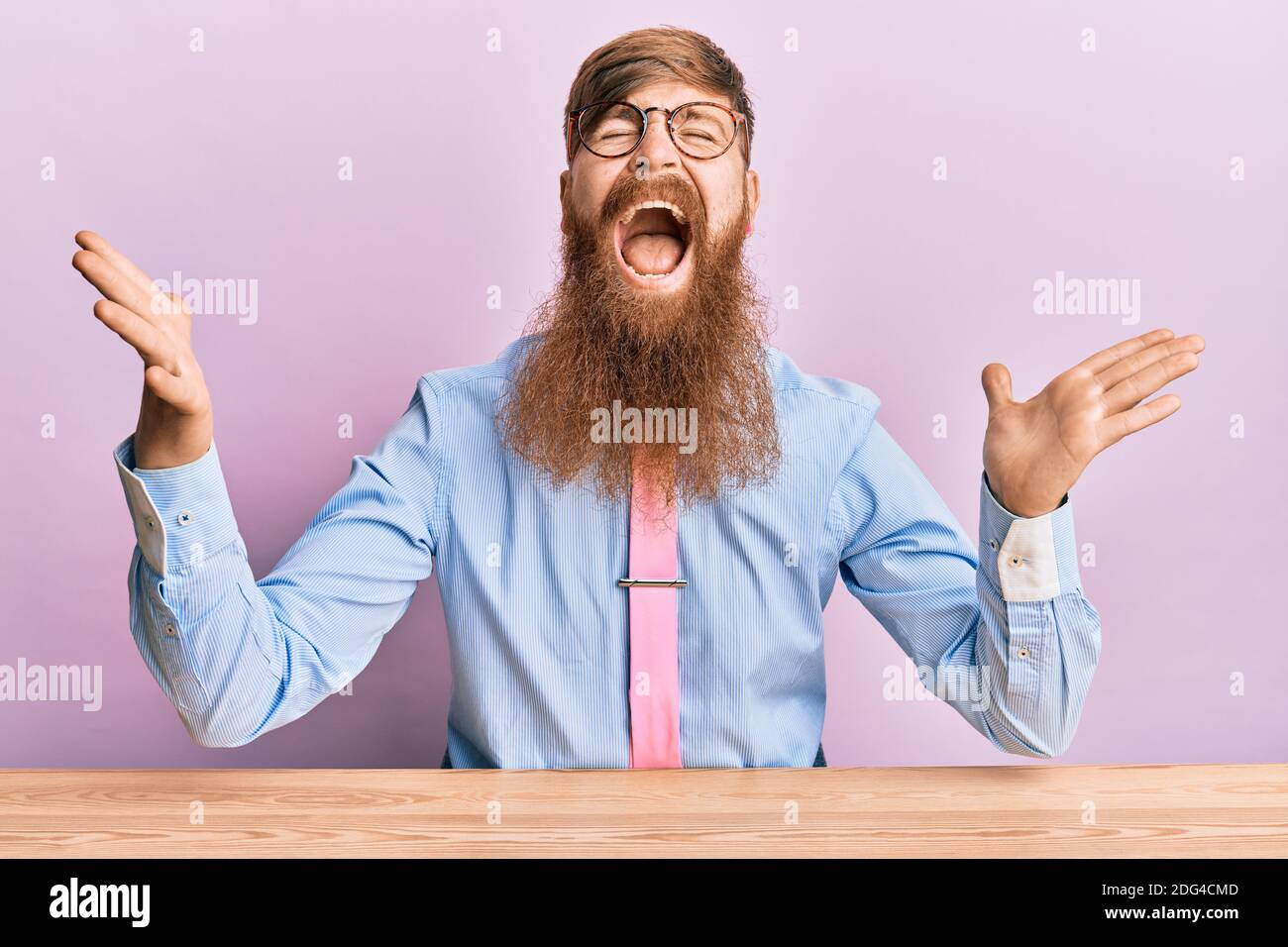 Young irish redhead man wearing business shirt and tie sitting on the ...