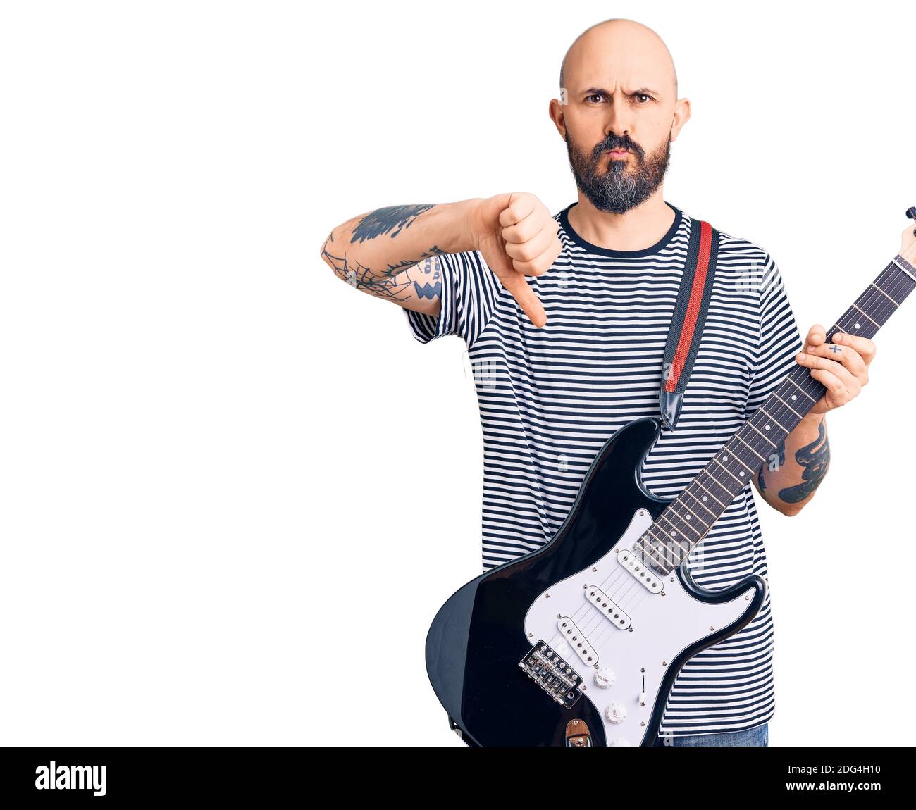 Young handsome man playing electric guitar with angry face, negative ...
