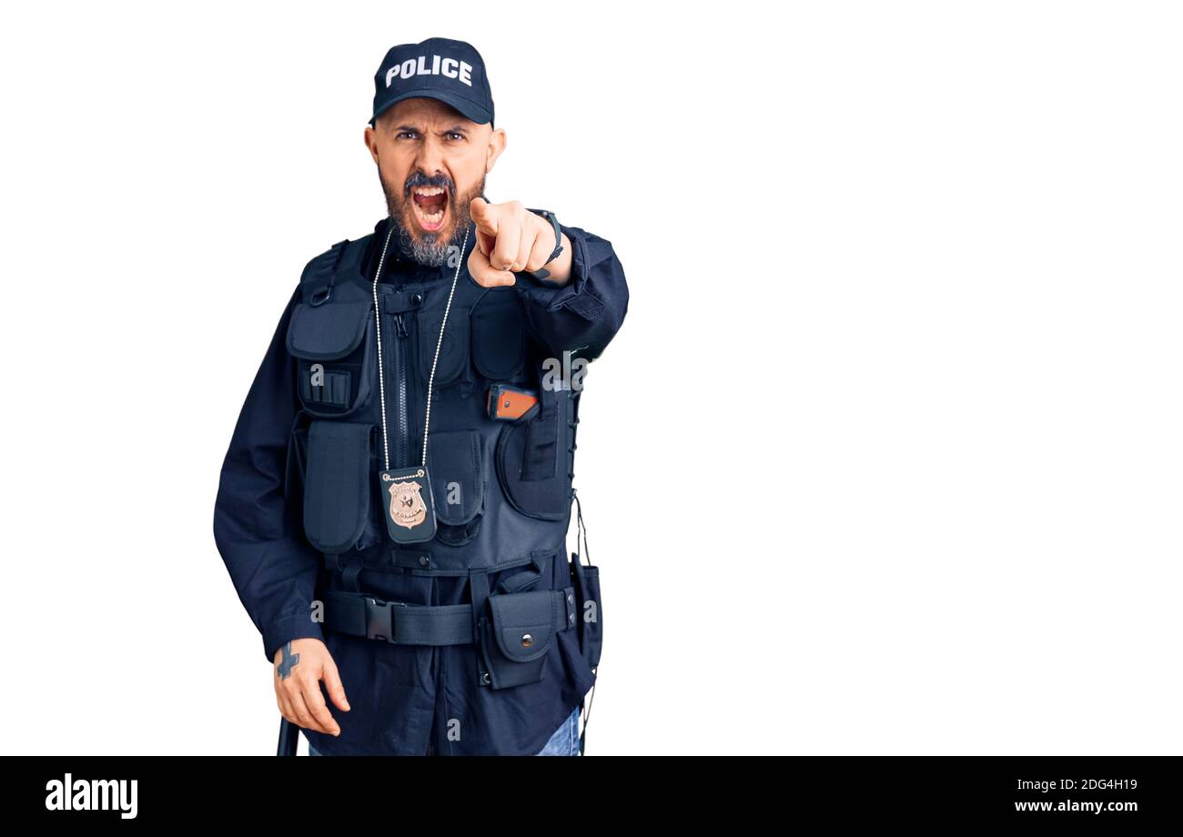 Young handsome man wearing police uniform pointing displeased and ...