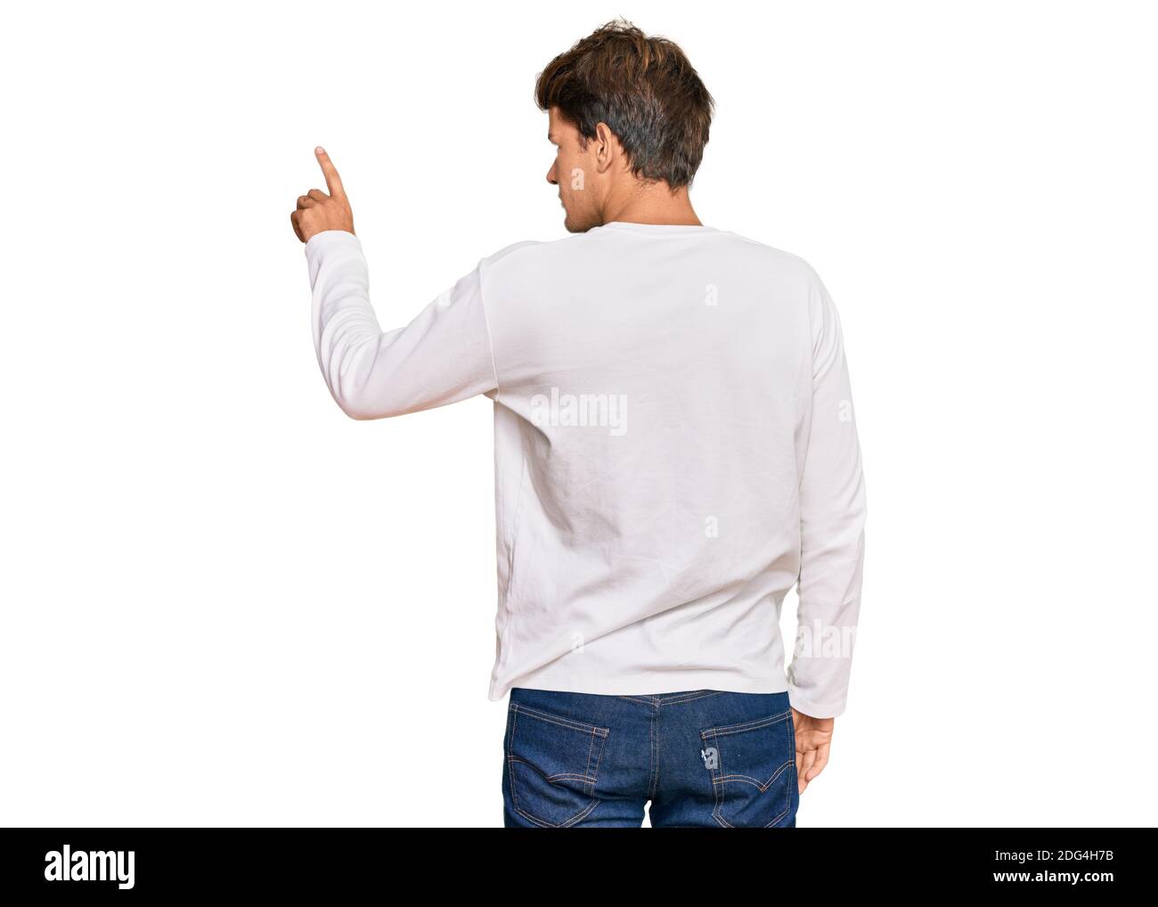 Handsome caucasian man wearing casual white sweater posing backwards ...