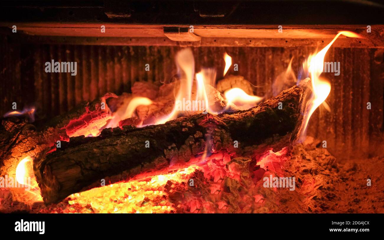 detail of the interior of a chimney with a burning oak trunk and red ...
