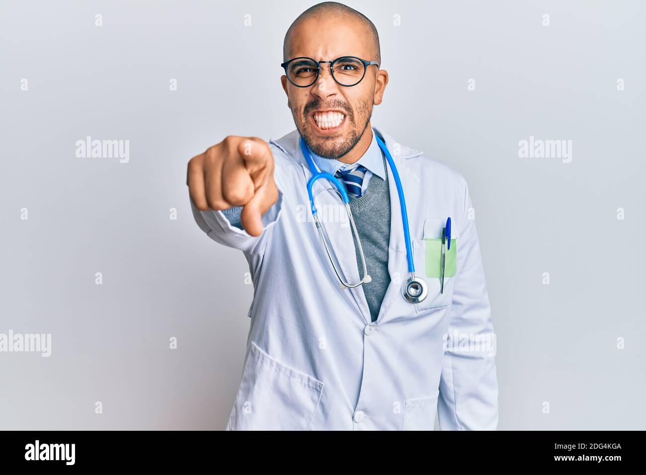 Hispanic adult man wearing doctor uniform and stethoscope pointing ...