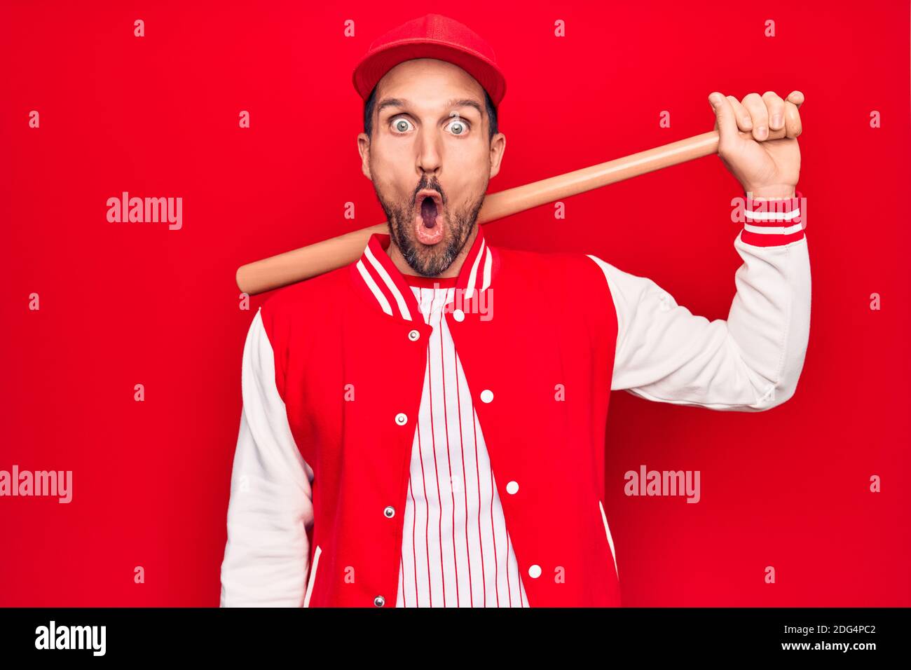 Young handsome player man wearing sportswear playing baseball using bat ...