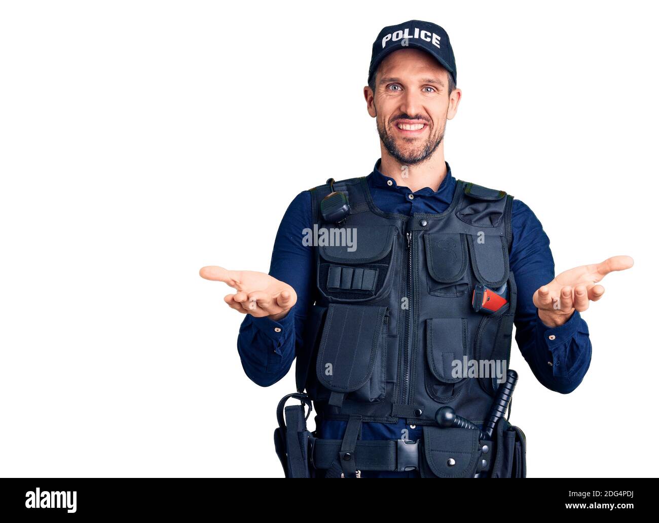 Young handsome man wearing police uniform smiling cheerful offering ...