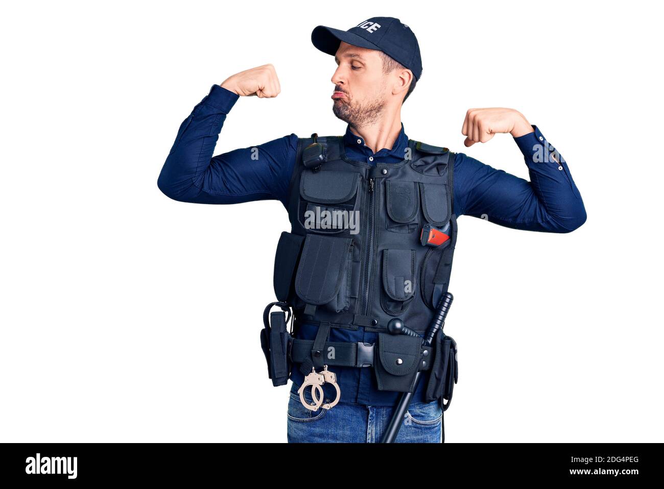 Young handsome man wearing police uniform showing arms muscles smiling ...