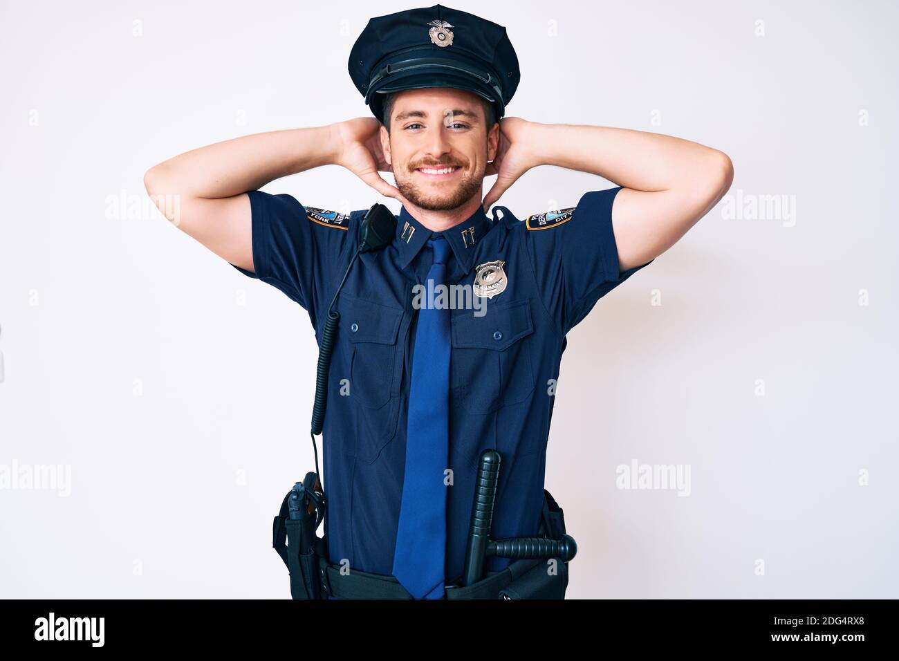 Young caucasian man wearing police uniform relaxing and stretching ...
